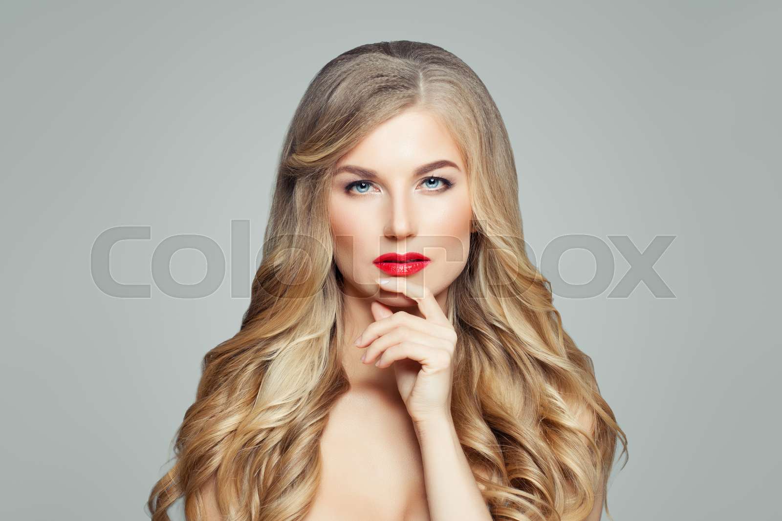 Elegant Blonde Woman With Long Wavy Hair Thinking Fashion Model